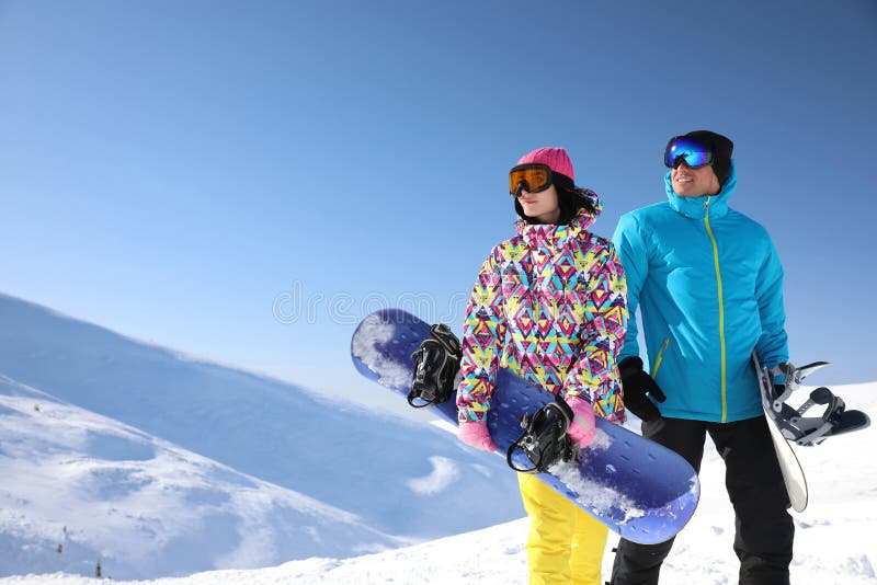 Couple with Snowboards in Mountains. Winter Vacation Stock Image ...