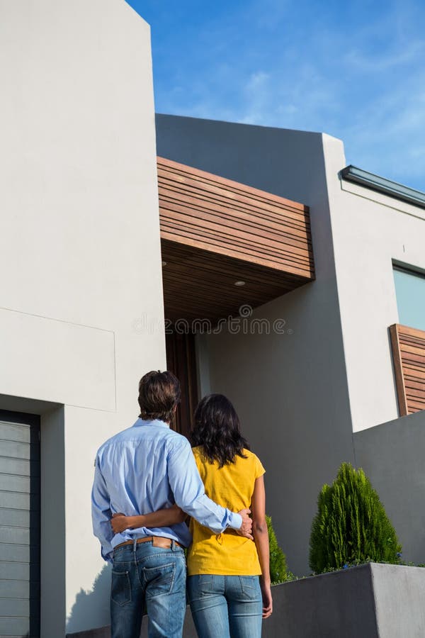 Happy Couple Standing and Looking at the New House Stock Photo - Image ...