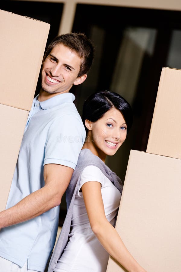 Happy Couple Stands Back To Back with Packages Stock Photo - Image of ...