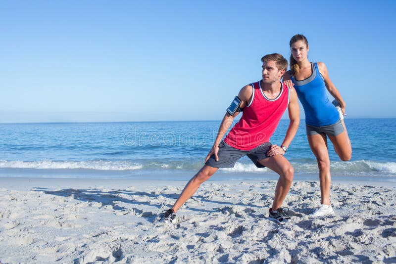 Happy Couple Stretching Together beside the Water Stock Image - Image ...