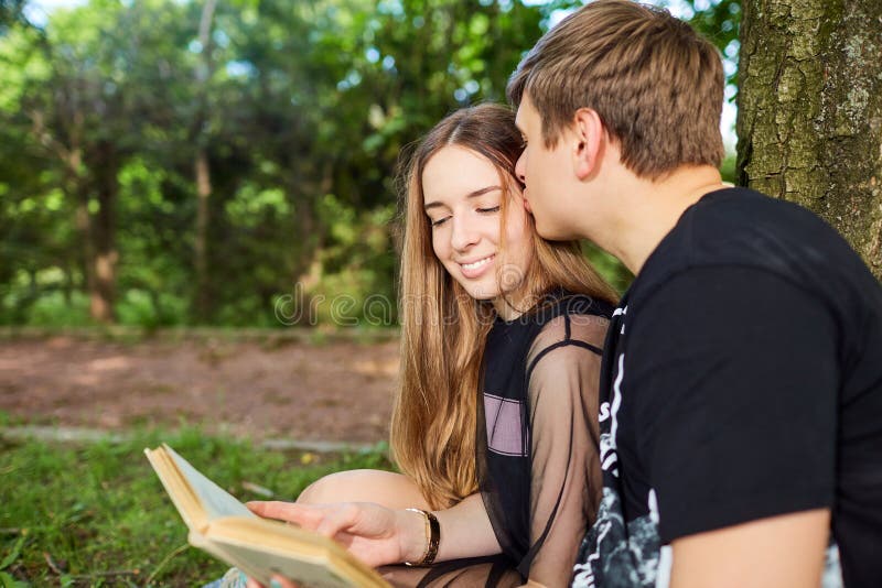 Happy Couple of Students are Reading a Book in the Park Stock Photo ...