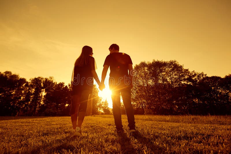 Happy Couple at Sunset in Park View from Behind Stock Photo - Image of ...