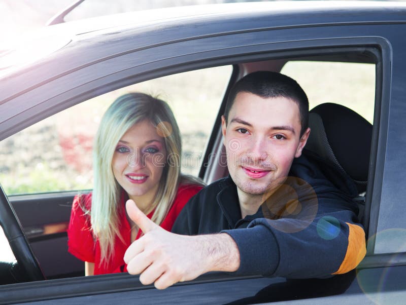 Happy couple in their car stock photo. Image of dealership - 140560194
