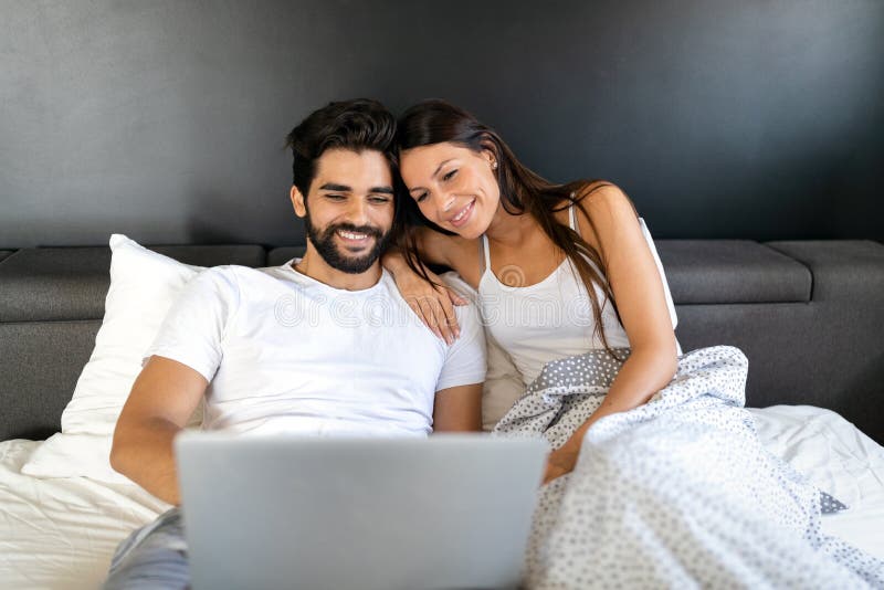 Happy Couple Using Laptop on Bed at Bedroom Stock Photo - Image of ...