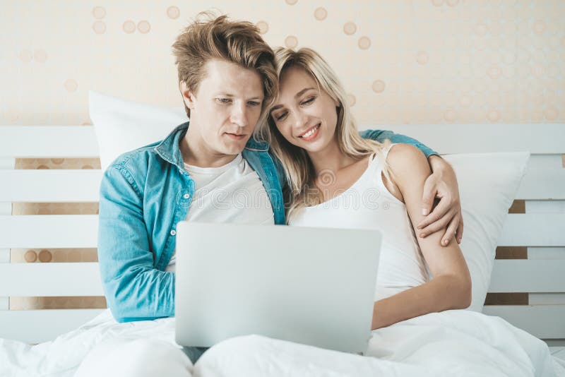 Happy Couple Using Laptop Computer Stock Image - Image of lying, female ...