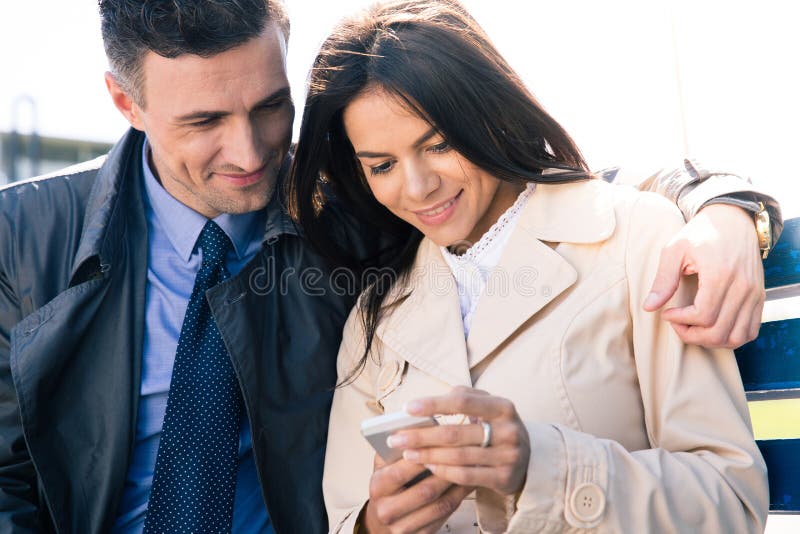 Happy Couple Using Smartphone Together Stock Image - Image of male ...