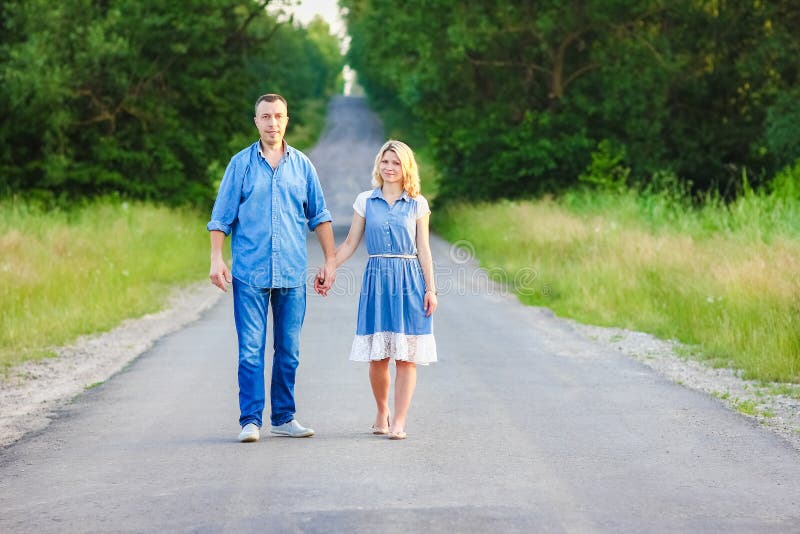 A Happy Couple Walking on the Road in Nature in the Park Stock Image ...