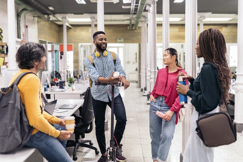 Happy Coworkers Talking in the Office Stock Photo - Image of ...