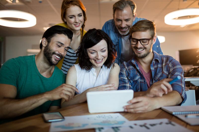 Happy Creative Business Team Discussing Over Digital Tablet Stock Photo ...