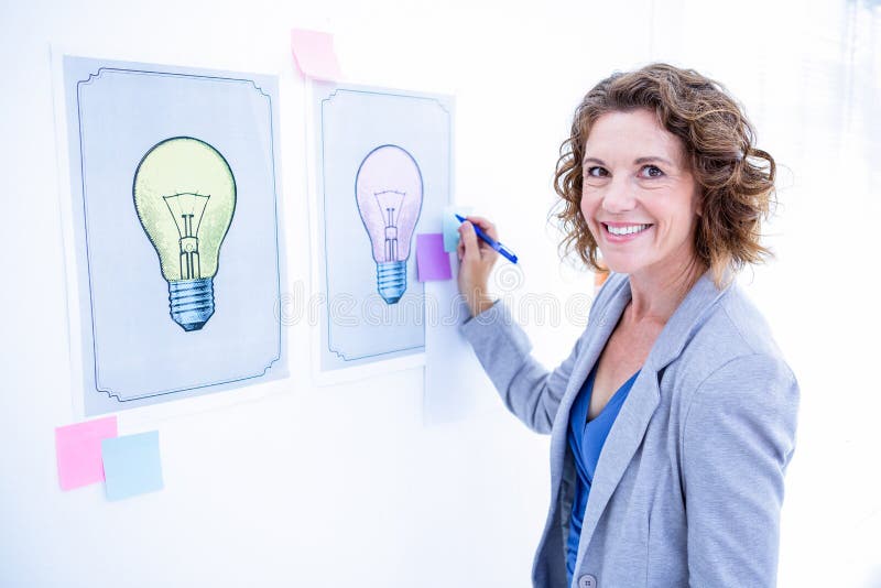 Happy Creative Businesswoman Writing on Post it Stock Photo - Image of ...