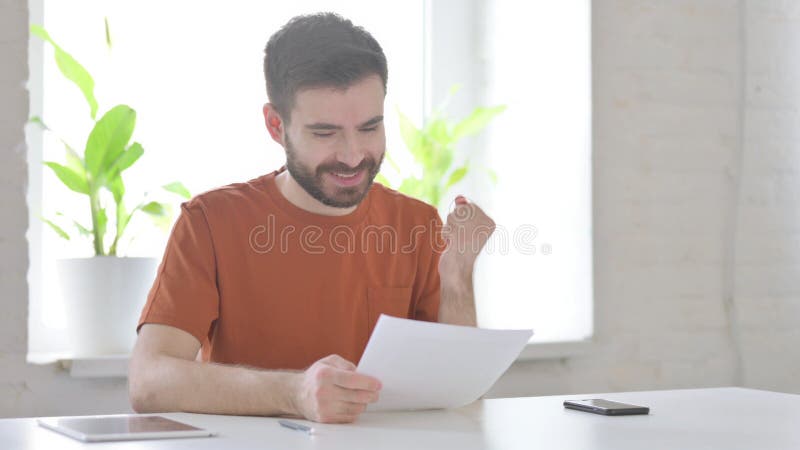 Happy Young Man Celebrating while Reading Documents Stock Photo - Image ...