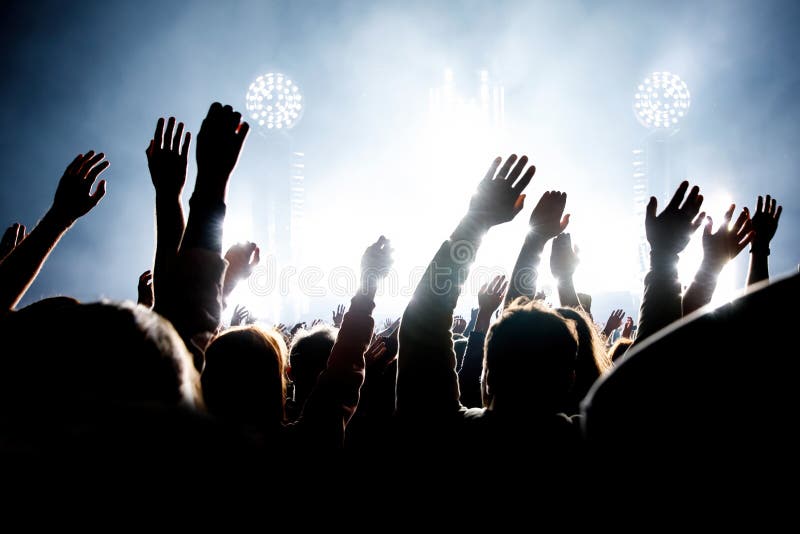 The Happy Crowd in a Concert Hall. Silhouettes of Raised Hands. Stock ...