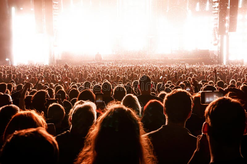 The Happy Crowd in a Concert Hall. Silhouettes of Raised Hands. Stock ...