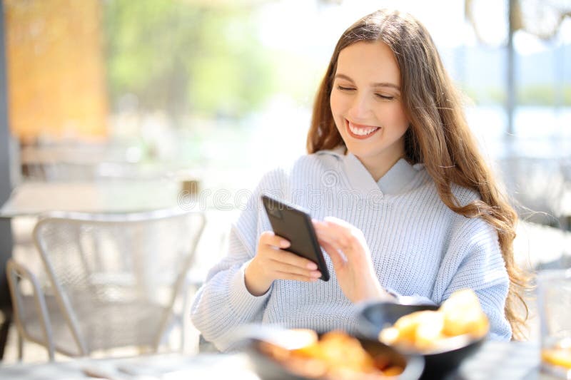 Happy Customer Using Cell Phone in a Restaurant Stock Photo - Image of ...