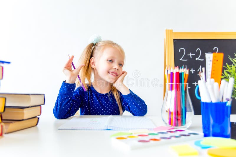 Happy Cute Industrious Child is Sitting at a Desk Indoors Stock Photo ...