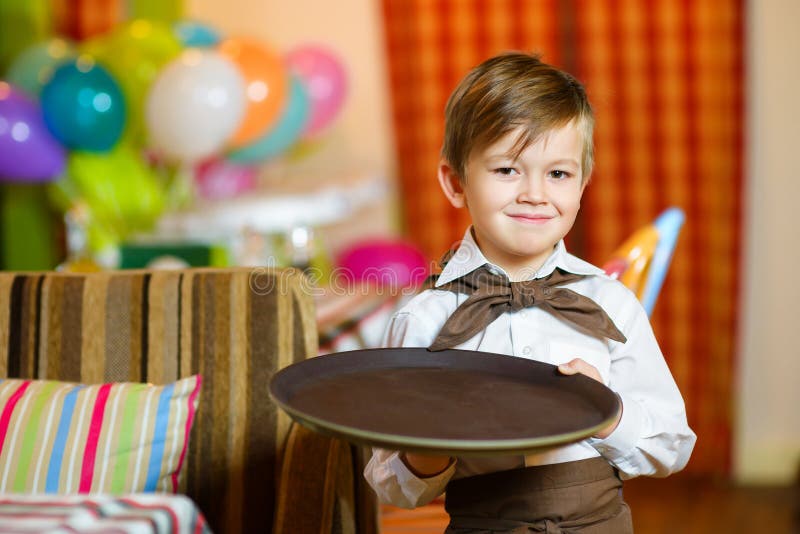 Happy Cute Little Boy Smiling Waiter Holding a Stock Photo - Image of ...