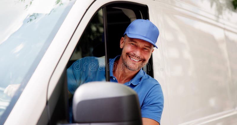 The Happy Delivery Man is Behind the Wheel of the Service Delivery Van ...