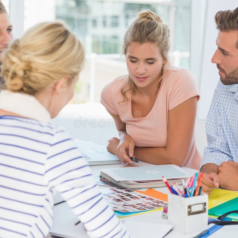 Happy Design Team Going Over Contact Sheets at a Meeting Stock Photo ...