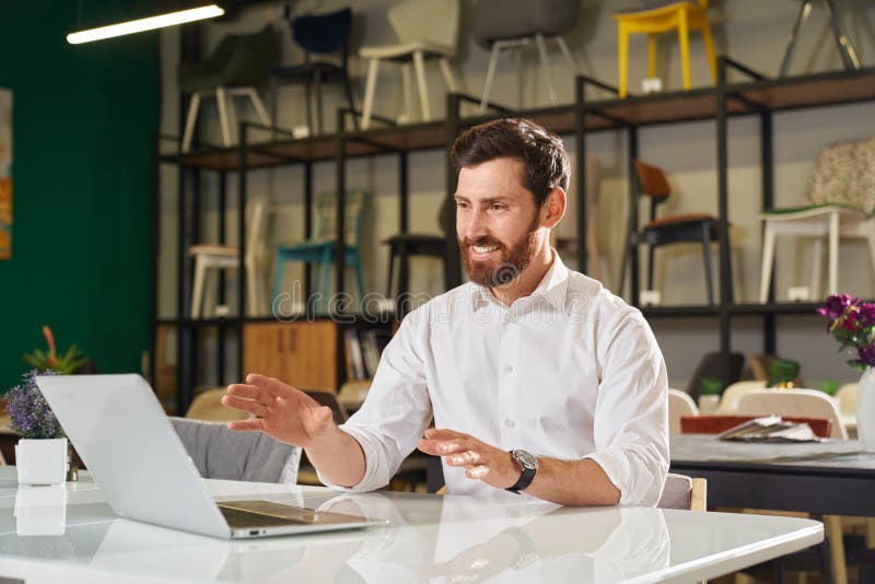 Happy Designer, Architect Sitting at Table, Working, Using Laptop ... Happy Designer, Architect Sitting at Table, Working, Using Laptop ...