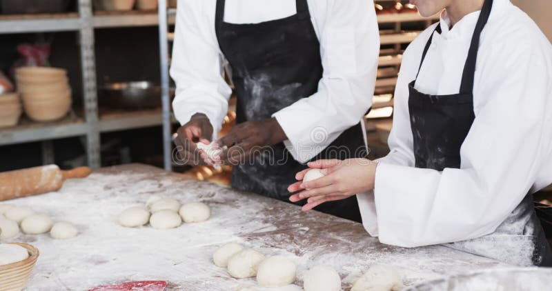 Happy Diverse Bakers Working in Bakery Kitchen, Making Rolls from Dough ...