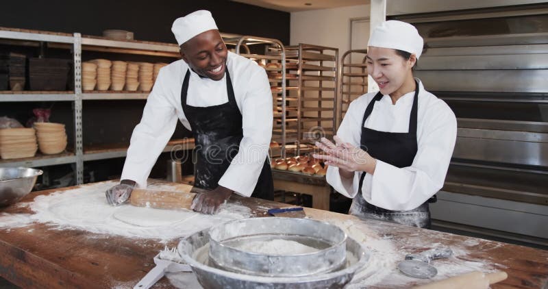 Happy Diverse Bakers Working in Bakery Kitchen, Rolling Dough on Counter in Slow Motion Stock ...