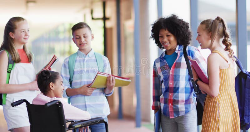 Happy Diverse and Disabled Schoolchildren Talking Together in School ...