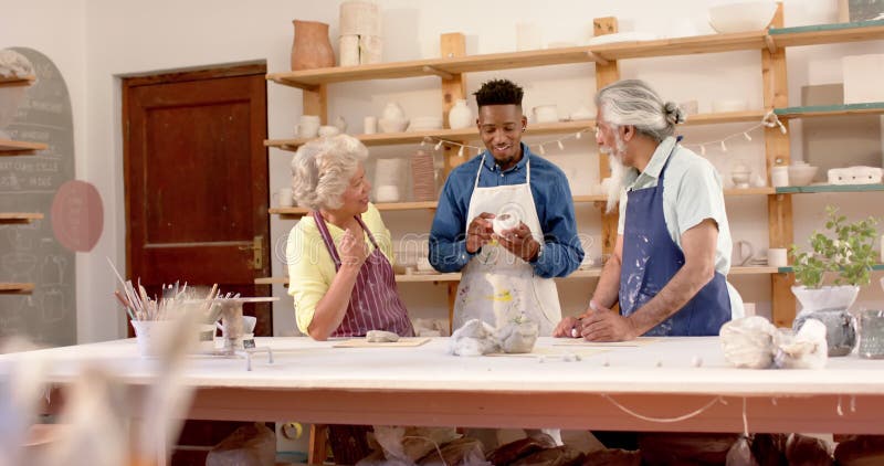 Happy Diverse Group of Potters Discussing about Work in Pottery Studio ...