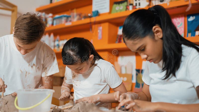 Happy Diverse Highschool Student Modeling Clay at Pottery Workshop ...