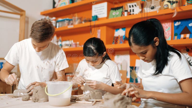 Happy Diverse Highschool Student Modeling Clay at Pottery Workshop ...