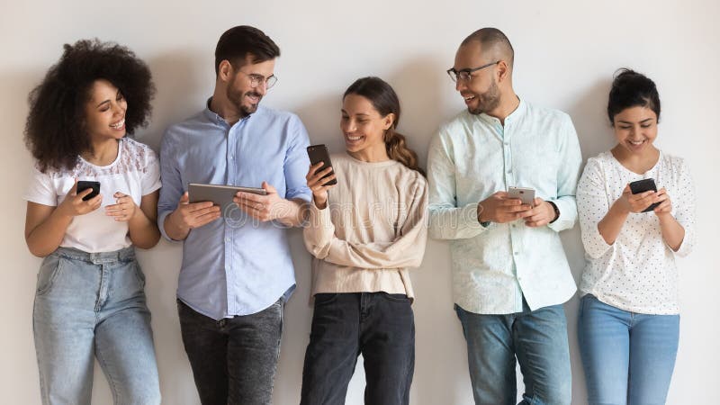 Happy Diverse Young People Using Different Electronic Devices. Stock ...