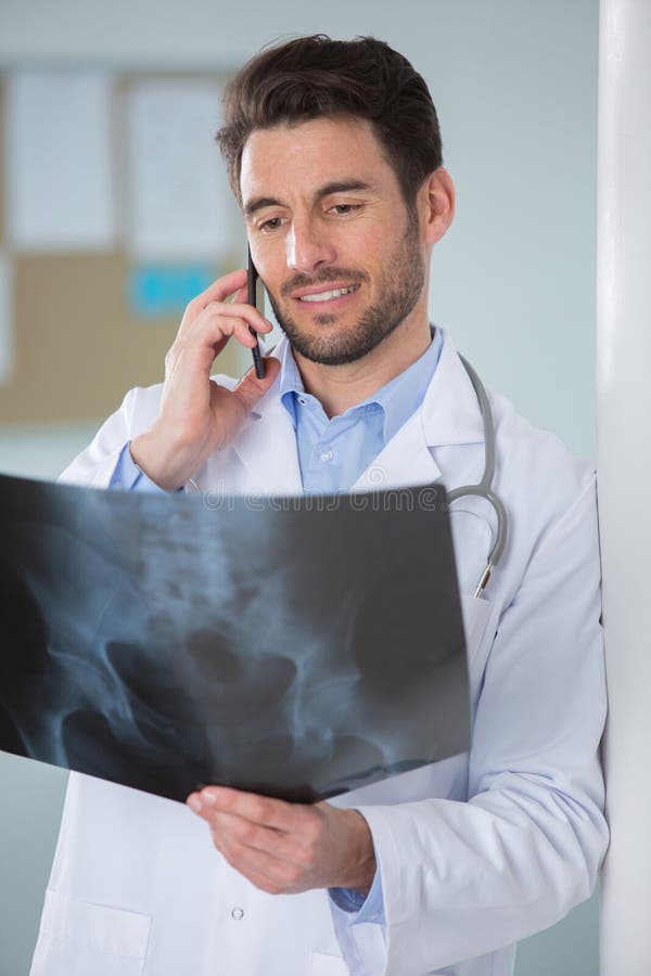 Happy Doctor on Phone with Xray Stock Photo - Image of radiologist ...