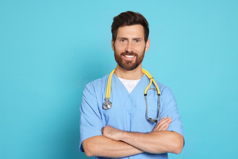 Happy Doctor with Stethoscope on Light Blue Background Stock Photo ...