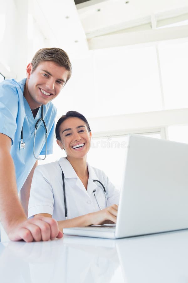Happy Doctors Looking at Camera Stock Photo - Image of coat, indoors ...