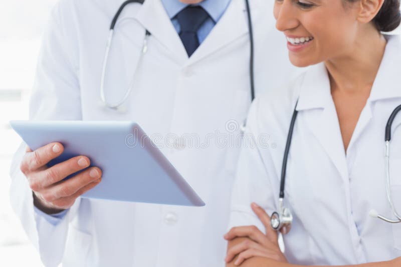 Happy Doctors Looking at Clipboard Stock Image - Image of adult ...