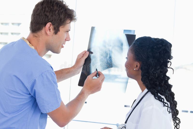 Happy Doctors Looking at a of X-ray Stock Photo - Image of confident ...