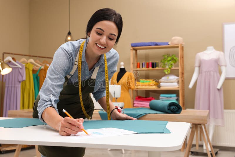 Happy Dressmaker Working at Table in Atelier Stock Photo - Image of ...