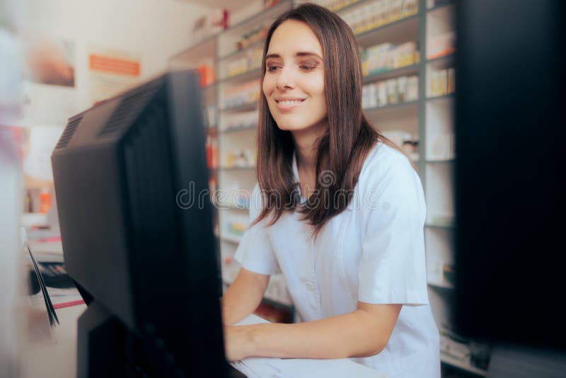 Pharmacist Using a Computer Looking for Stock Supplies in Database ...