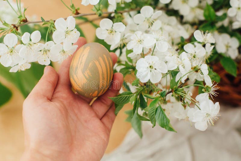 Happy Easter. Hand Holding Modern Easter Egg on Background of Blooming ...