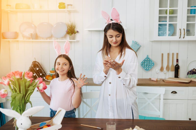 Happy Easter! Mom and Daughter are Having Fun, Painting Hands while ...