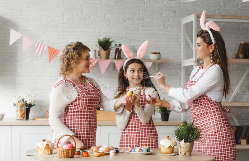 Happy Easter. Mother and Daughters Draw Easter Eggs. a Happy Family is ...