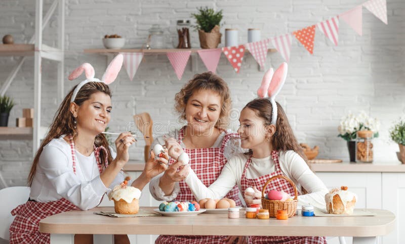 Happy Easter. Mother and Daughters Draw Easter Eggs. a Happy Family is ...