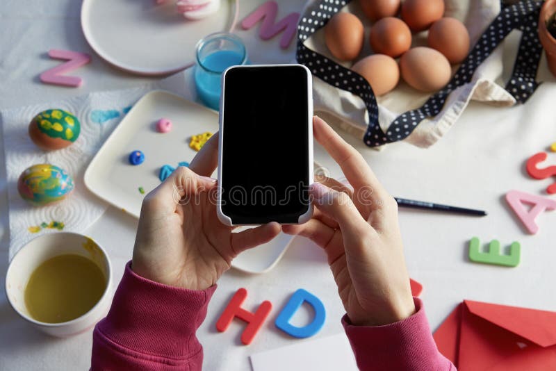Happy Easter Preparing. Female Hands Holding Mobile Phone and Making ...