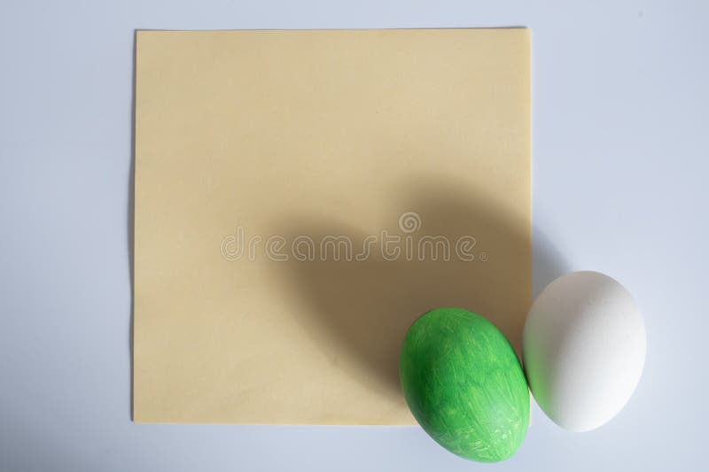 Happy Easter. Two Eggs Placed on Plain Brown Paper Against a White ...