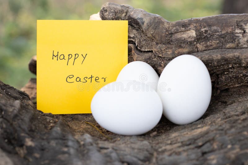 Happy Easter Words Written in Yellow Sticky Note and 3 White Eggs Place ...