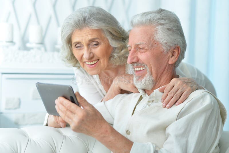 Happy Elderly Couple Using a Tablet Computer Stock Image - Image of ...