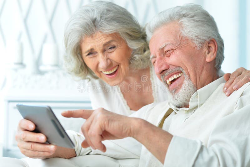 Happy Elderly Couple Using a Tablet Computer Stock Photo - Image of ...