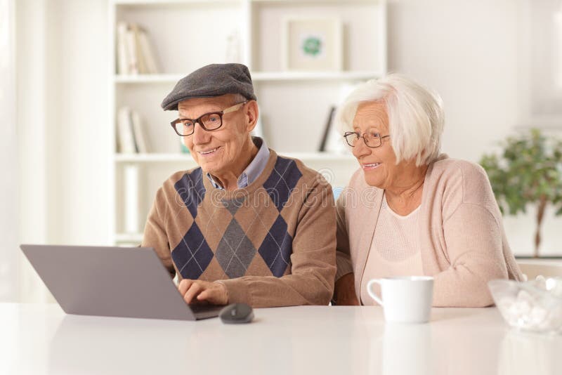 Happy Elderly Man and Woman Using a Laptop Computer Stock Photo - Image ... Happy Elderly Man and Woman Using a Laptop Computer Stock Photo - Image ...