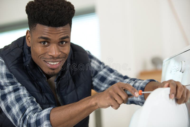 Happy Electrical Worker Screwing Washing Machine Stock Photo - Image of ...