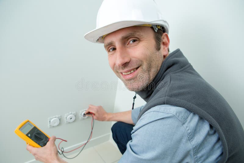 Happy Electrician Gesturing Thumbs Up by Ladder Stock Photo - Image of ...