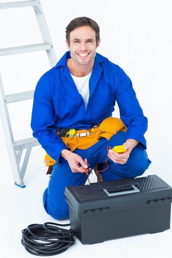 Happy Electrician Gesturing Thumbs Up by Ladder Stock Photo - Image of ...